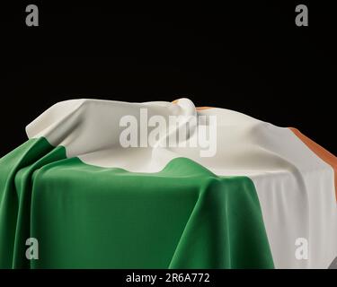 A irealnd flag draped over a stone plinth on an isolated dark studio ...
