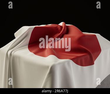 A japan flag draped over a stone plinth on an isolated dark studio ...