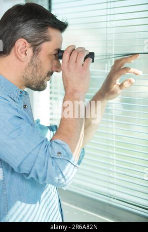 Private detective with modern camera spying on city street Stock Photo ...