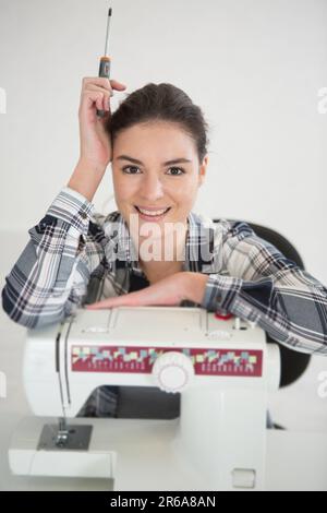 Beautiful young dressmaker in workroom Stock Photo - Alamy