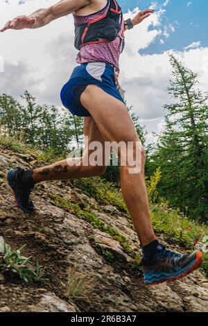 close-up legs male runner running on gray asphalt marathon race Stock ...