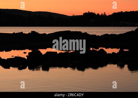 sunrise over calm water - Lysaker Stock Photo - Alamy