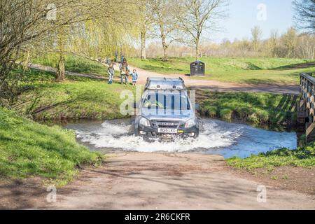 4x4 Council vehicle driving through a water ford in a country park ...