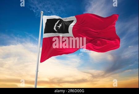 official flag of Kuala Nerus, Terengganu Malaysia at cloudy sky background on sunset, panoramic ...