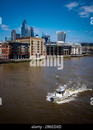A river boat on the River Thames sails underneath Waterloo Bridge as a ...