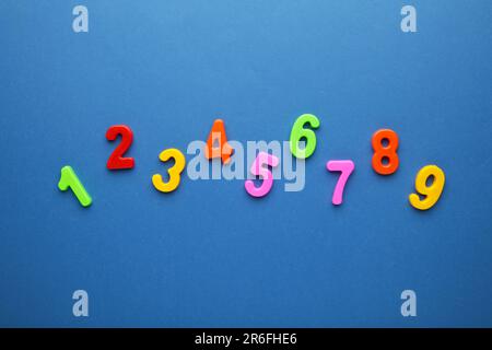 Magnetic multi-coloured figures on purple background. Back to school ...