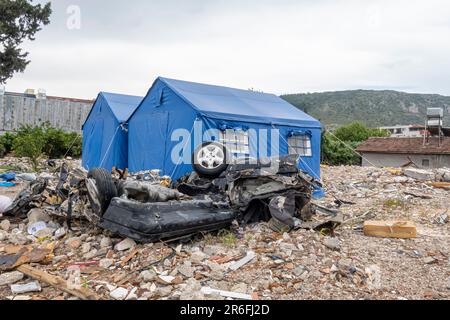Destroyed car, smashed cars, tents, rubble. Turkish city Antakya in ...