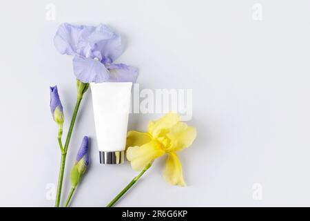 Yellow cosmetic container on gray background top view Stock Photo - Alamy