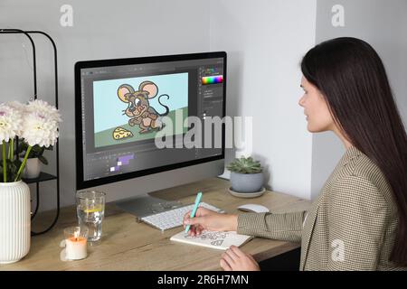 Animator working at table. Modern computer with illustration on screen ...