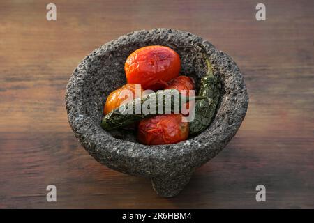 Ingredients for salsa sauce in stone bowl on wooden table, top view ...