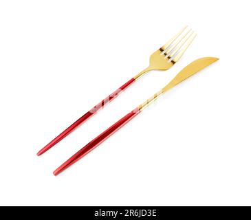 Golden fork and knife with red handles on white background Stock Photo ...