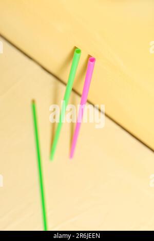 Different plastic straws on color background Stock Photo - Alamy