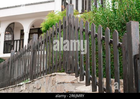 Low wooden shabby fence near building outdoors Stock Photo - Alamy
