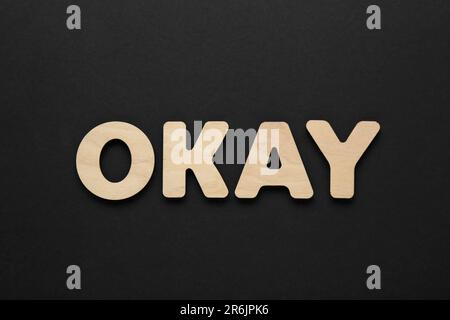 Word Okay made of wooden letters on crumpled paper, top view Stock ...