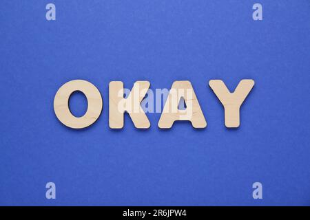 Word Okay made of wooden letters on yellow background, top view Stock ...