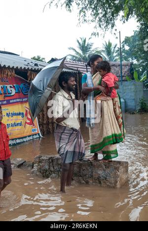 People standing on a culvert village logged on rain water, Tamil Nadu ...