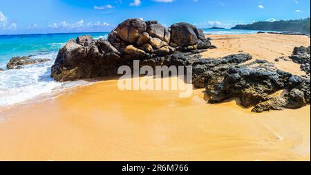 Exposed Lava Reef On The Sandy Shore With Kilauea Lighthouse in The ...