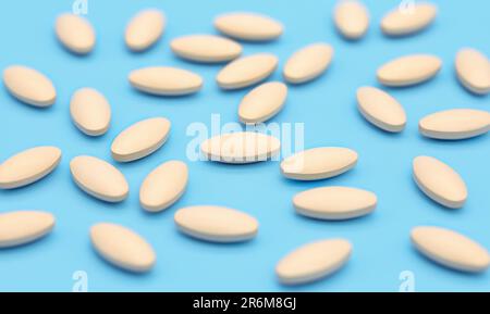 oval-shaped tablets lie on a contrasting background Stock Photo - Alamy
