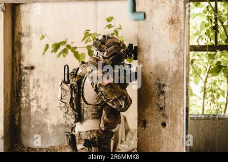 Smart teamwork of soldiers running forward and attacking enemy during ...