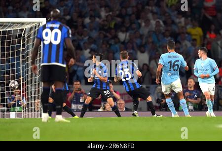 Manchester City's Rodri (right) scores their side's first goal of the ...