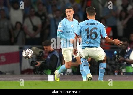 Manchester City's Rodri (right) scores their side's first goal of the ...