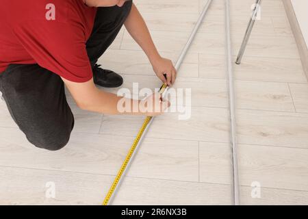 Worker measuring metal pipes for installation, closeup Stock Photo - Alamy