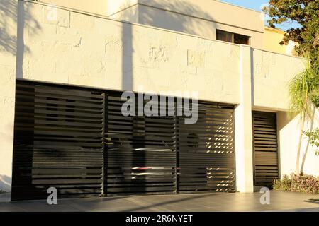 Closed gates of modern garage. Exterior design Stock Photo - Alamy