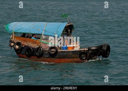 Sampans, traditional small fishing boats, crossing Victoria Harbour ...