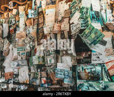 Collection of paper currency from around the world pinned to a bulletin ...