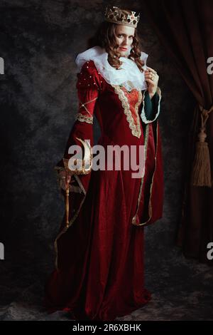 insidious medieval queen in red dress with white collar and crown on ...