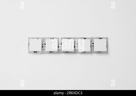 Modern plastic switches on white wall. Installing lighting Stock Photo ...