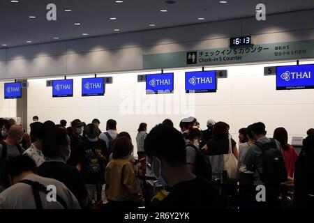 Passengers of Thai Airways flight TG683 going through the formalities ...