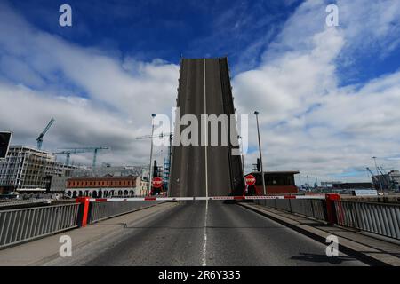 The Tom Clarke Bridge over Liffey River opening up for a ship. Dublin ...