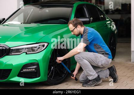 Mechanic checking tire service via insurance system at garage. Safety ...