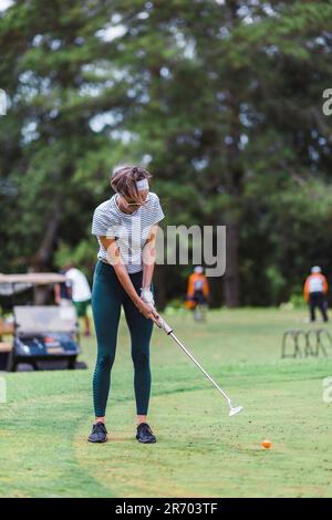 Woman playing golf, Bedugul, Bali, Indonesia Stock Photo - Alamy