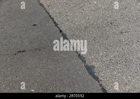 The repaired part of an asphalt road with patches, repair and ...