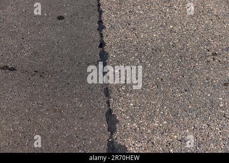 The repaired part of an asphalt road with patches, repair and ...