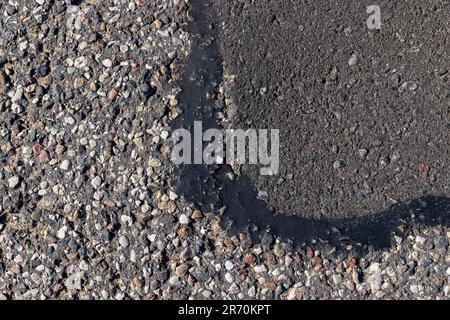 The repaired part of an asphalt road with patches, repair and ...