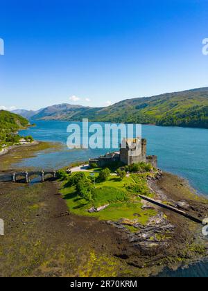 An aerial view of Eilean Donan Castle in the Scottish Highlands on a ...