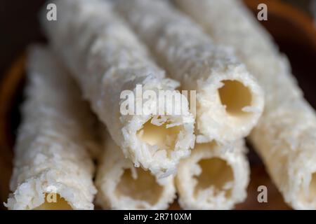 Waffle tubes with butter cream and coconut sprinkles, sweet waffle ...