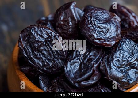 Dried plums on the kitchen table, dried sweet pitted prunes Stock Photo ...