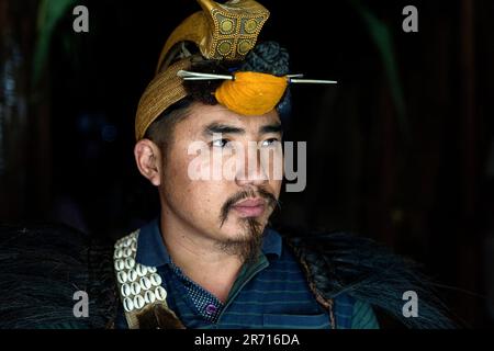 Portrait of a Nyishi man in his traditional tribal clothes with ...