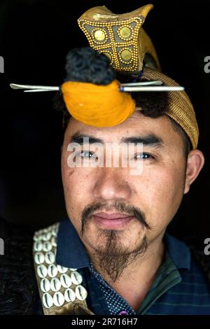 Portrait of a Nyishi man in his traditional tribal clothes with ...