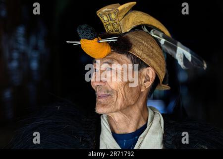 Portrait of a Nyishi man in his traditional tribal clothes with ...