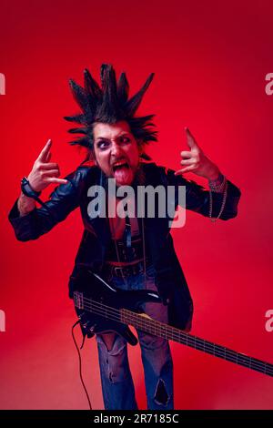 Aggressive impressive pose. Rok musician, man posing with hand gesture ...