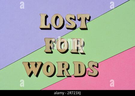 Lost For Words, phrase in wooden alphabet letters isolated on colourful ...