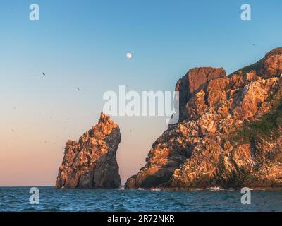 Moon rising over Ireland's Eye Stock Photo - Alamy