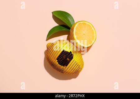 Disco balls with lemon inside on yellow background Stock Photo - Alamy