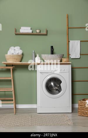 Stylish laundry room with functional washing machine. Interior design ...