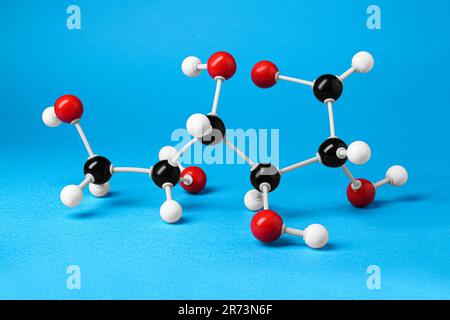 Molecule of glucose on light blue background, closeup. Chemical model ...